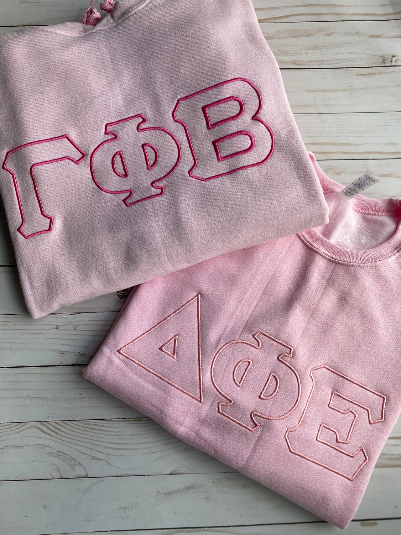 light pink monochromatic embroidered greek sweatshirts $ 50 . 00 $ 55 . 00